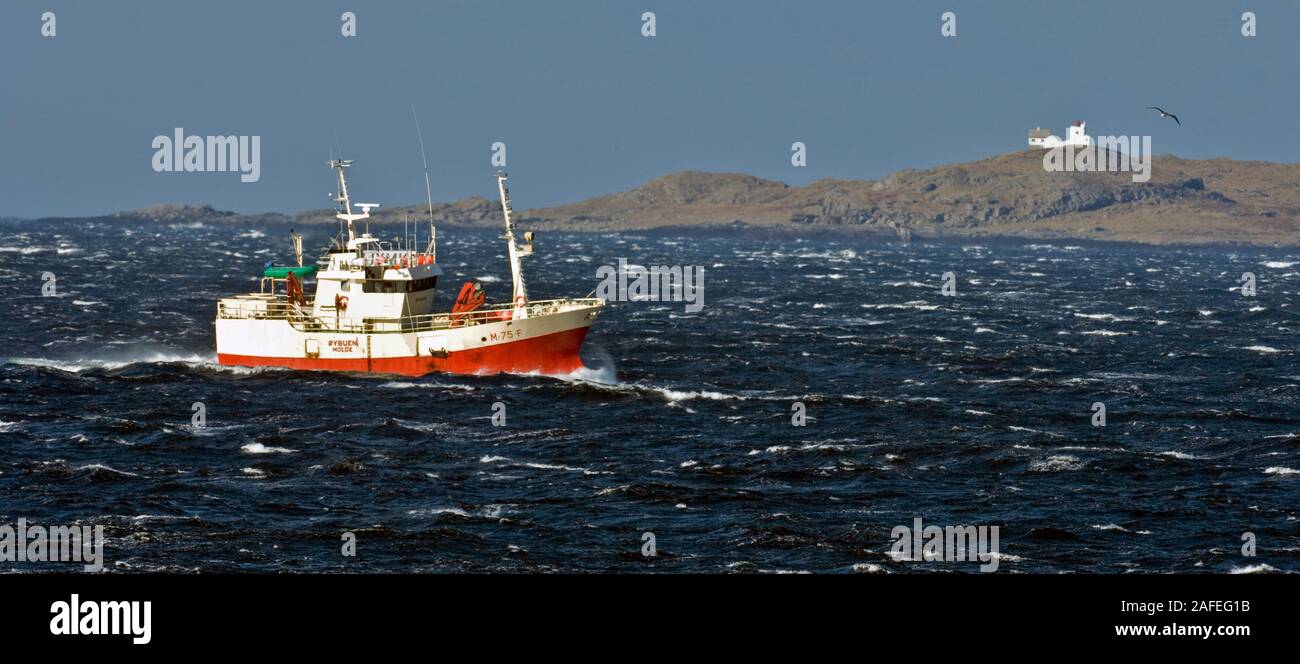 Norwegian trawler off Alnes, a small island with a traditional lifght ...
