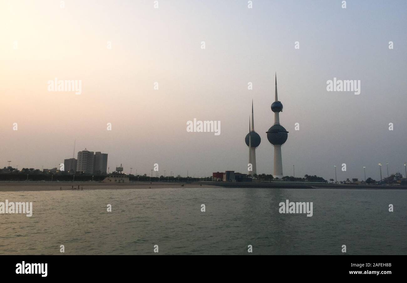 Amazing colorful Kuwait cityscape during sunset, view from sea port ...