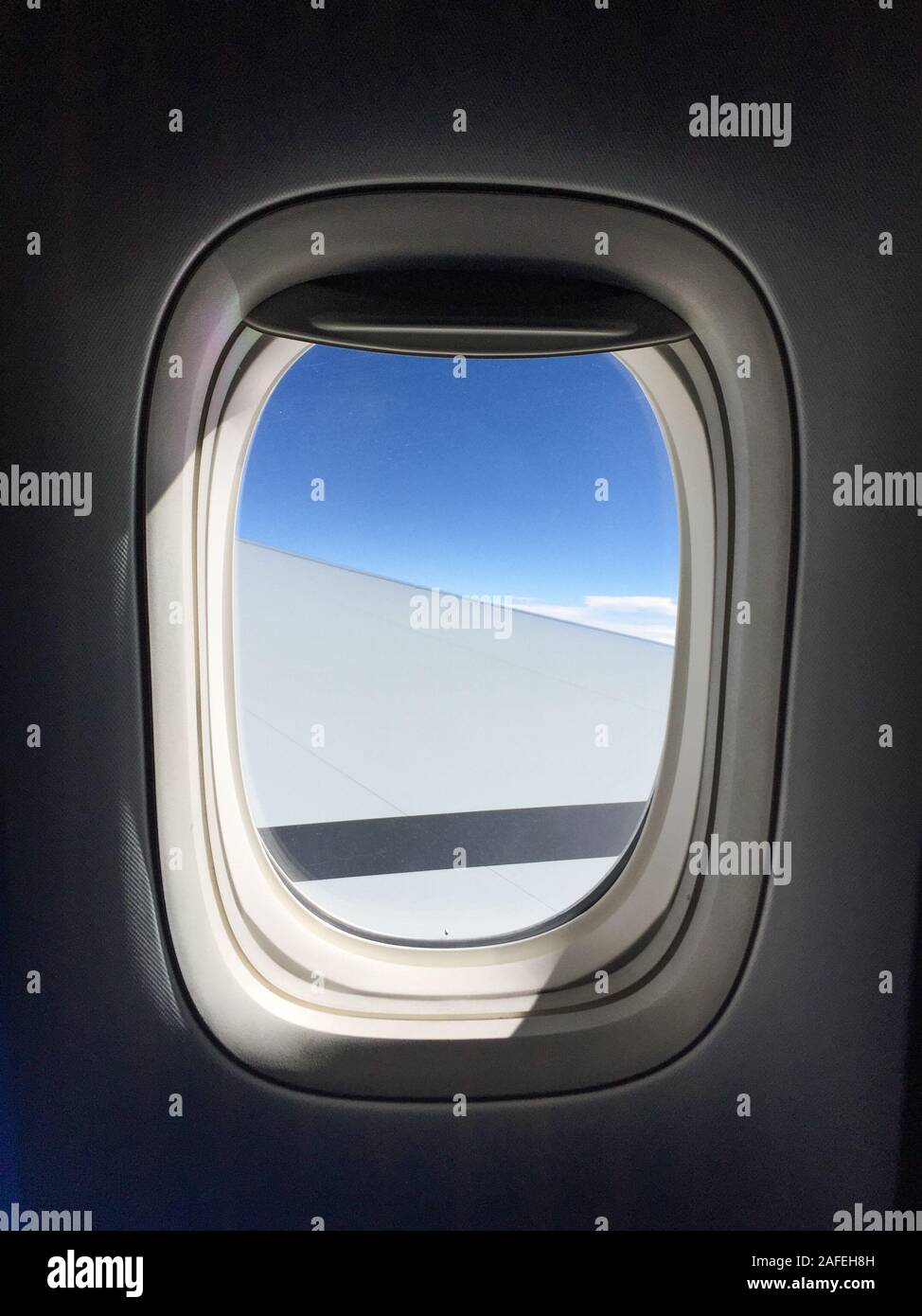 Airplane window with blue sky background. Travel concept Stock Photo ...