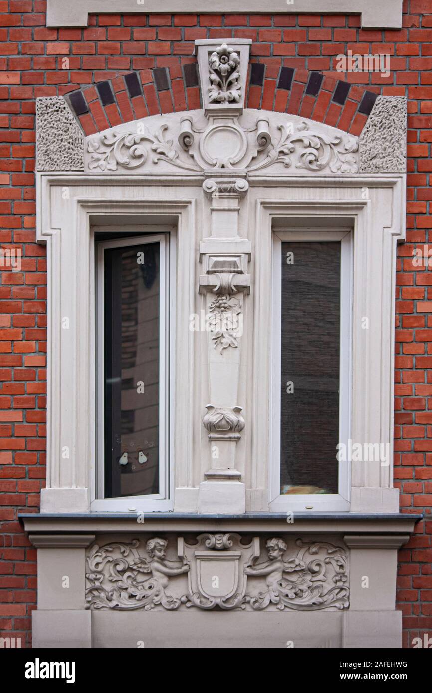 Old tenement house with brick wall detail window with german stucco ...