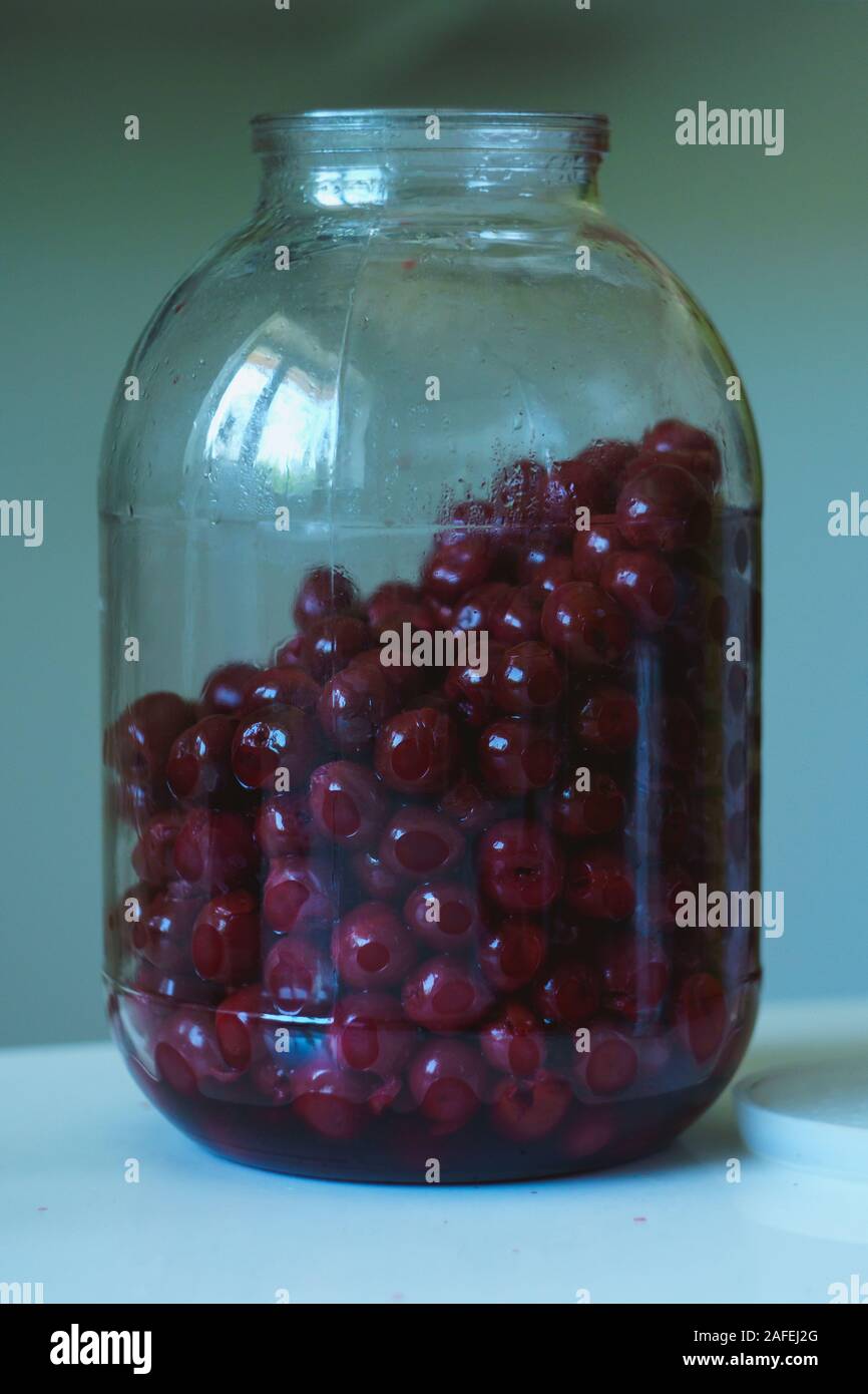 Colorful photo of a three liter jar filled with alcohol soaked cherries ...