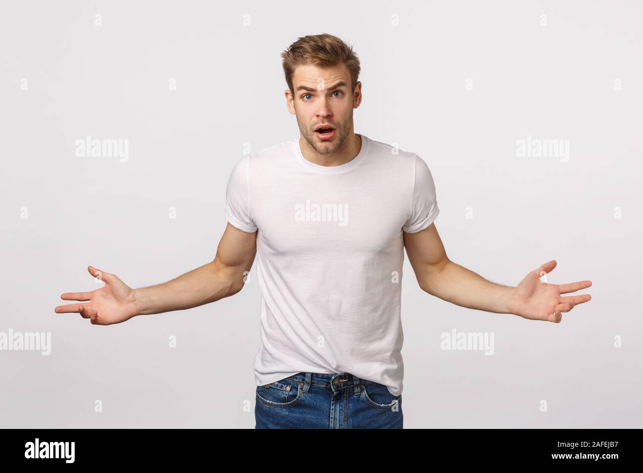 Aggressive and angry guy waiting explanation. Pissed blond male spread ...