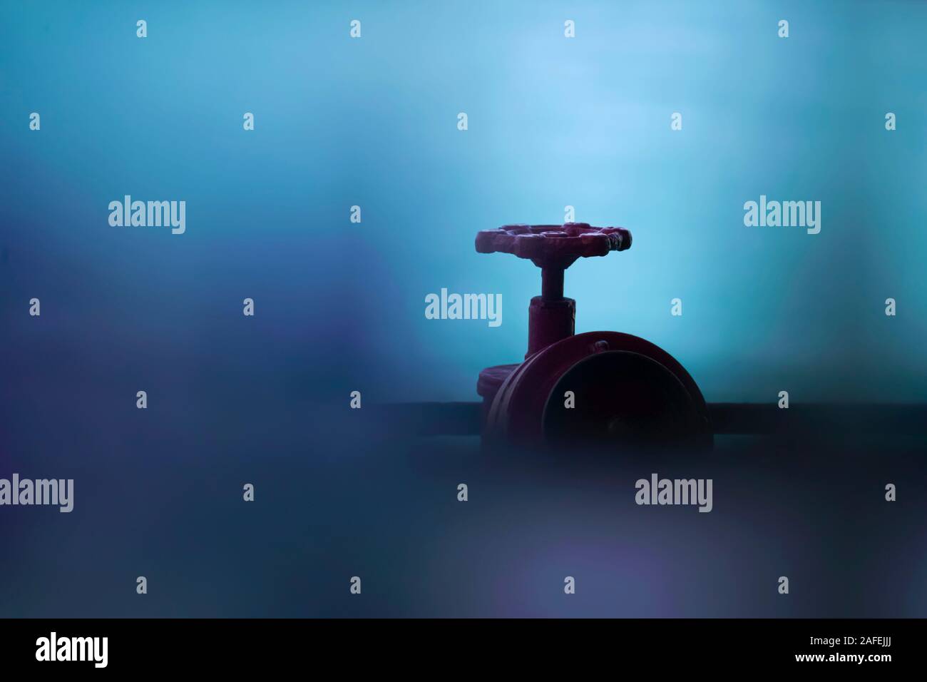 Selective focus on a mains metallic valve with blue background Stock ...