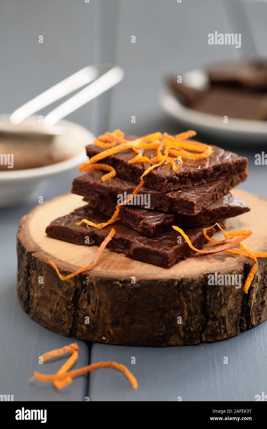Healthy homemade dark chocolate bars with orange rind on wood slabs ...