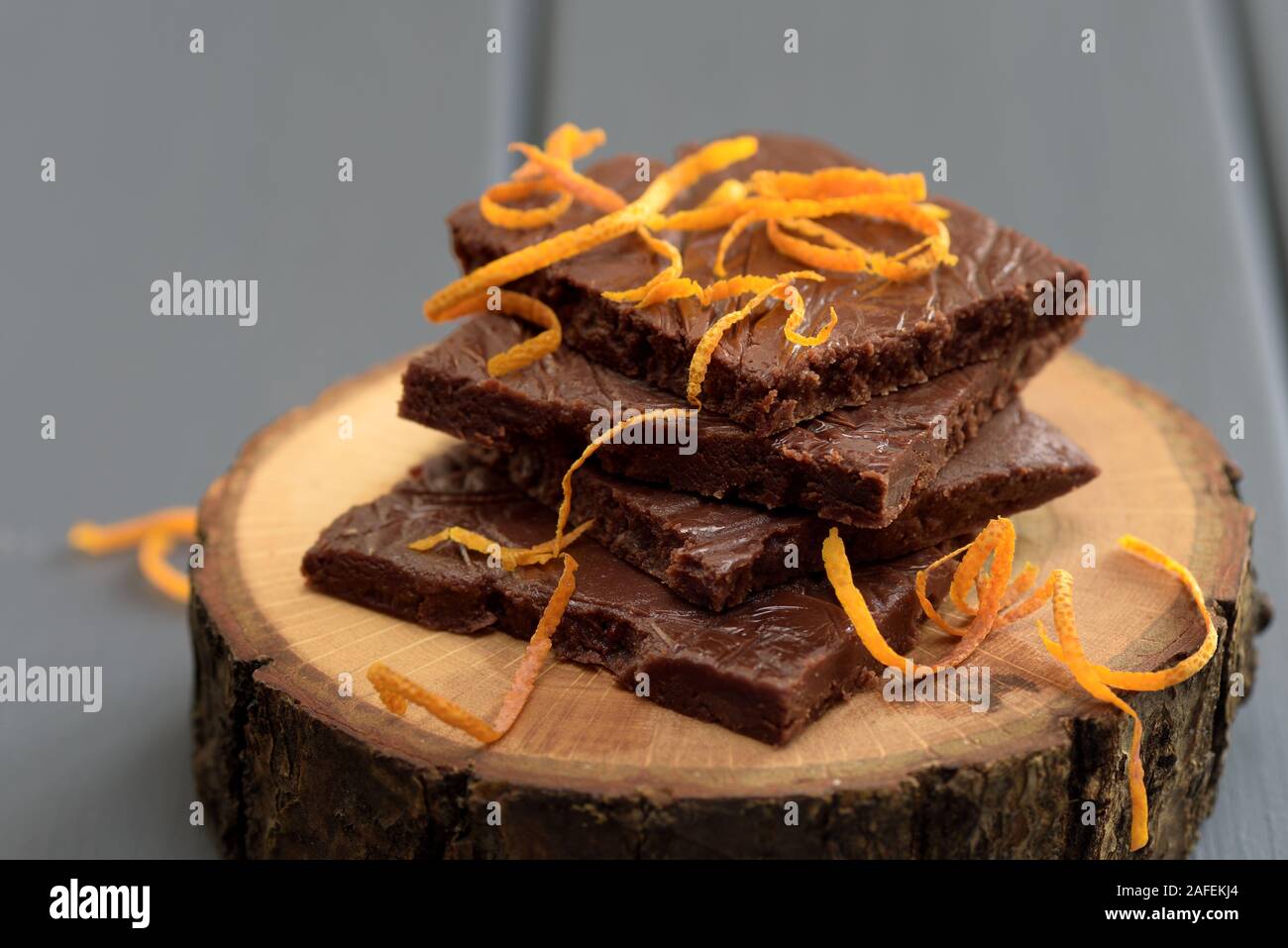 Healthy tasty dark chocolate bars with fresh orange rind on wood stands ...