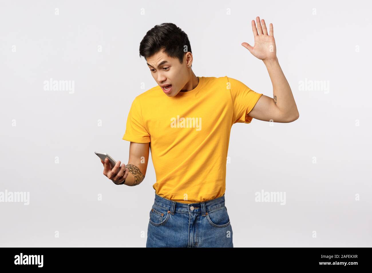 Guy losing in arcade game and raising hand expressive and disappointed ...