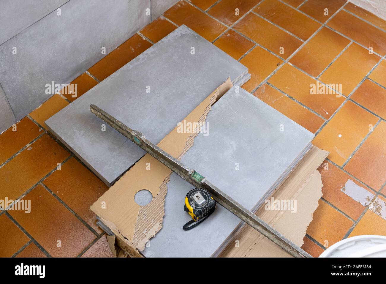ceramic tile installation site with its tools Stock Photo - Alamy