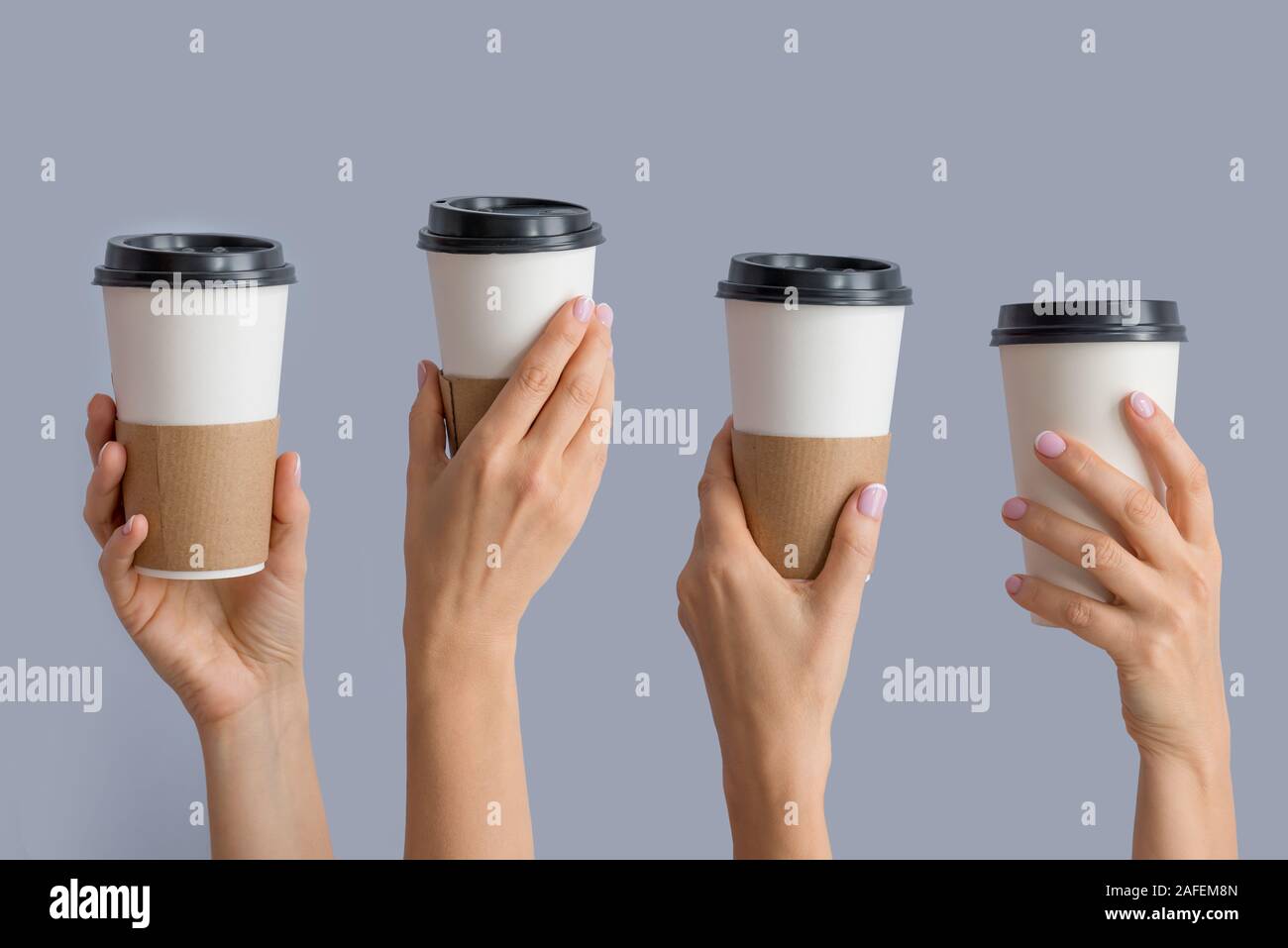 Mockup of several female hands holding up a Coffee paper cup Stock ...