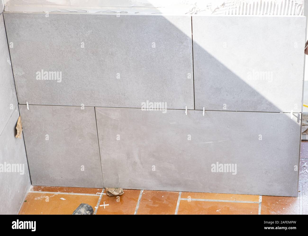 ceramic tile installation site with its tools Stock Photo - Alamy
