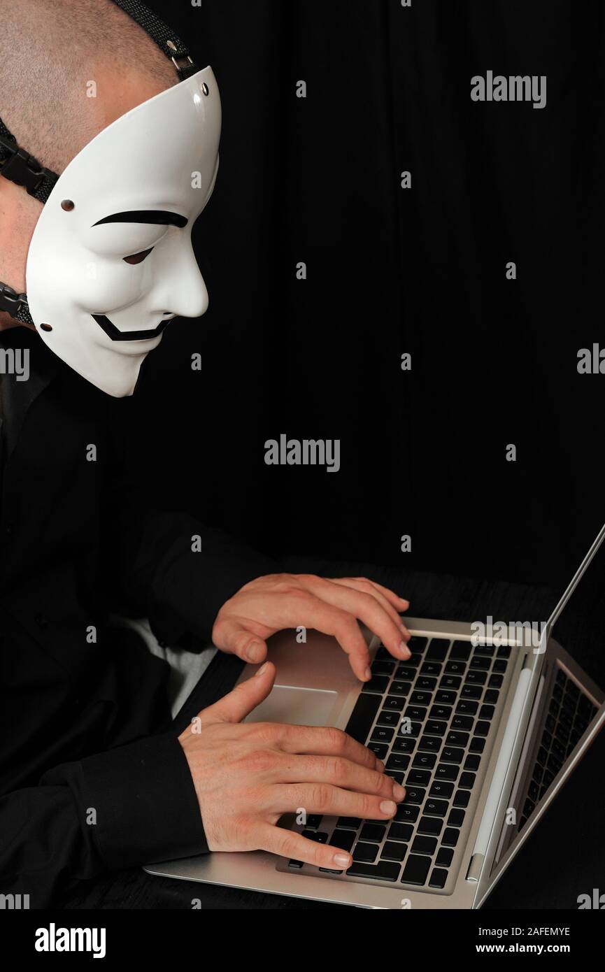 member of the Anonymous hacker group in front of the laptop Stock Photo ...