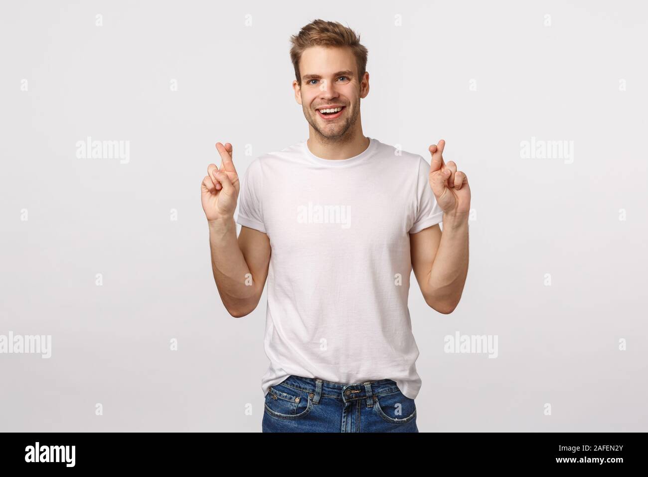 Man having high hopes. Enthusiastic lucky attractive blond guy, cross ...