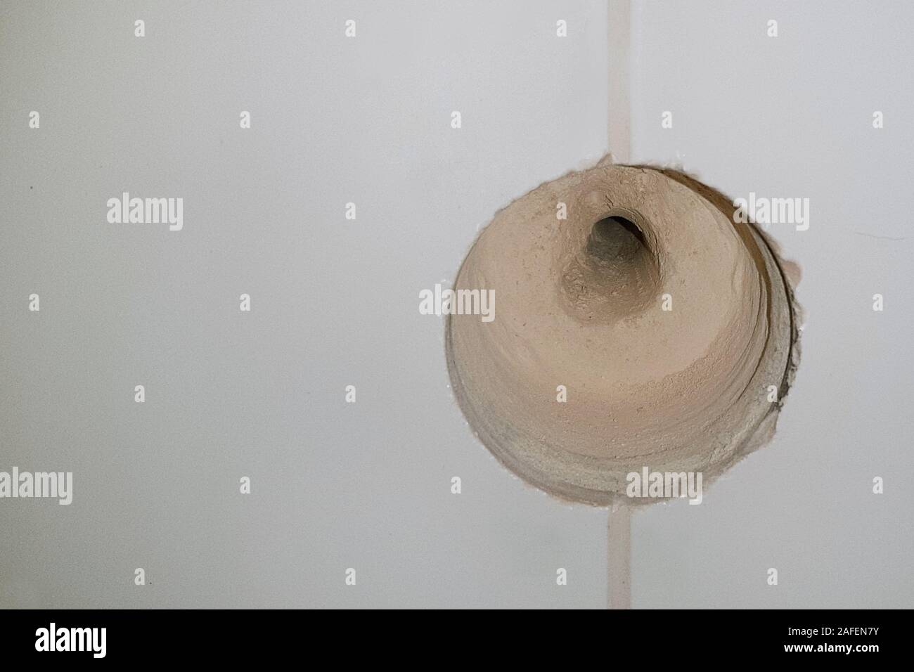 The hole in the wall, plug installation Stock Photo - Alamy