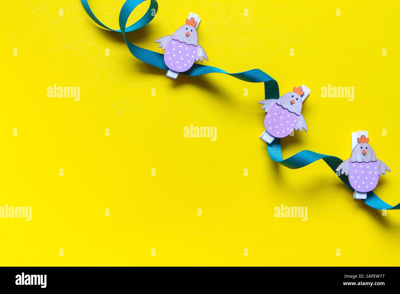 Easter decoration, garland of colored wooden chicken figures on a ...