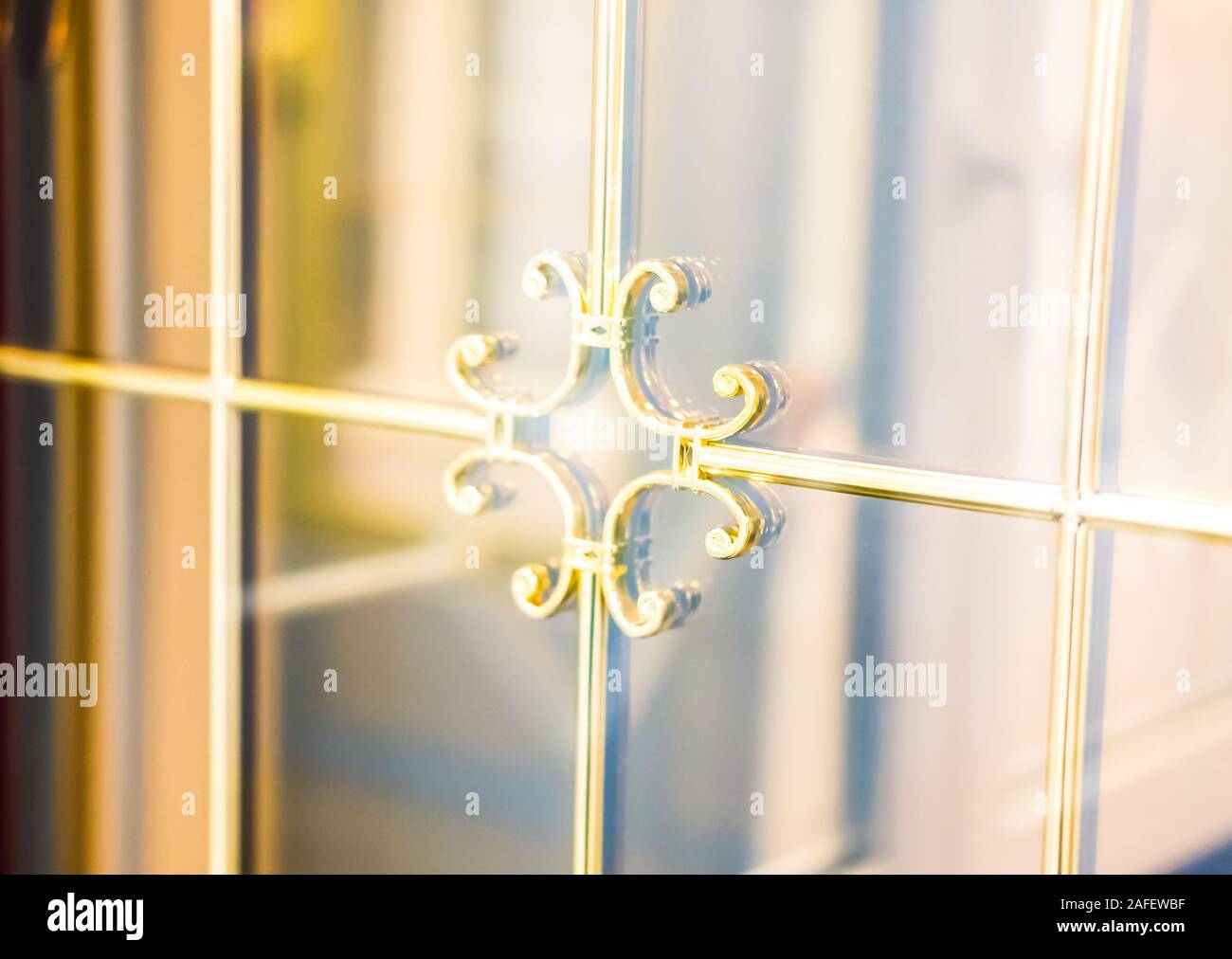 Window glass with golden element Stock Photo - Alamy