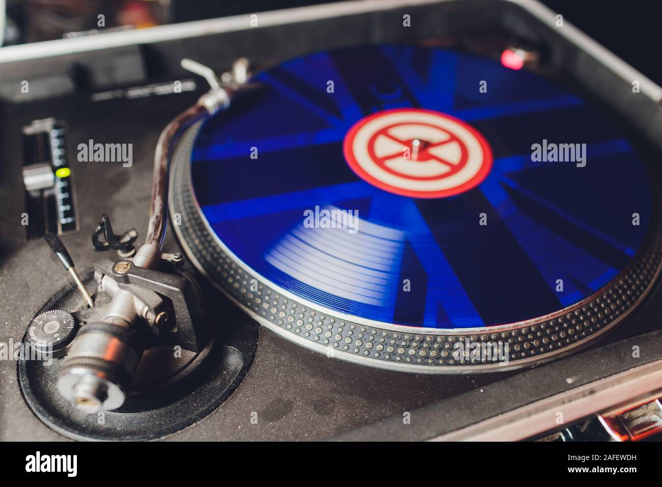 Dj hands on equipment deck and mixer with vinyl record at party Stock ...