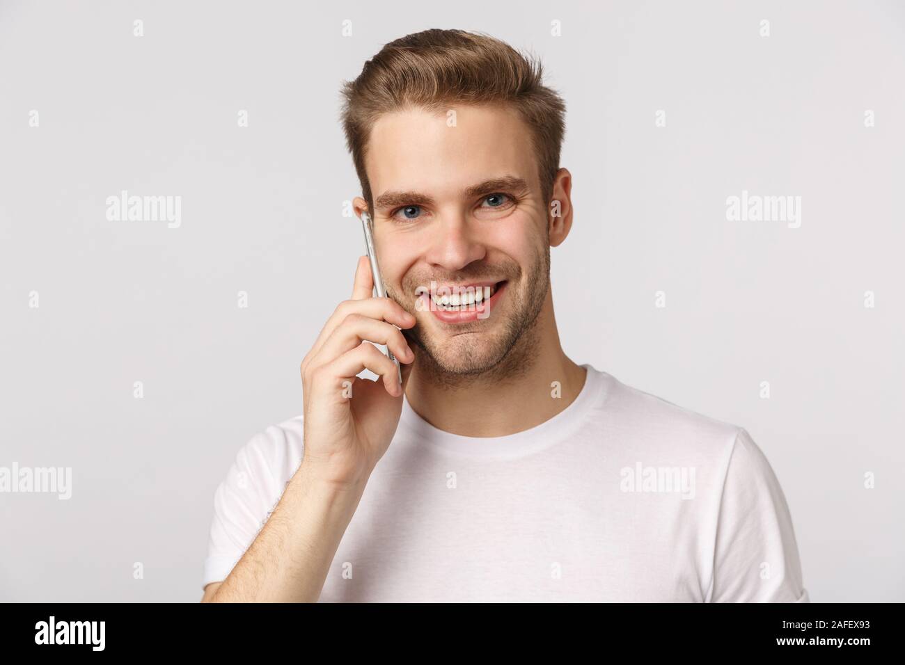 Hello im listening. Friendly good-looking smiling blond caucasian guy ...