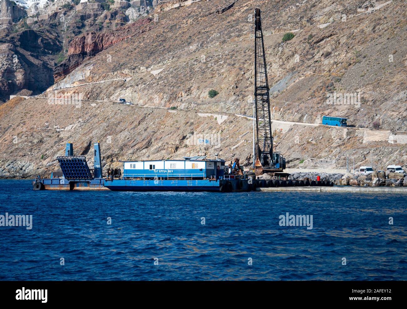 Ormos Athinios, Greece - July 16 2019: A crane behind the commercial ...