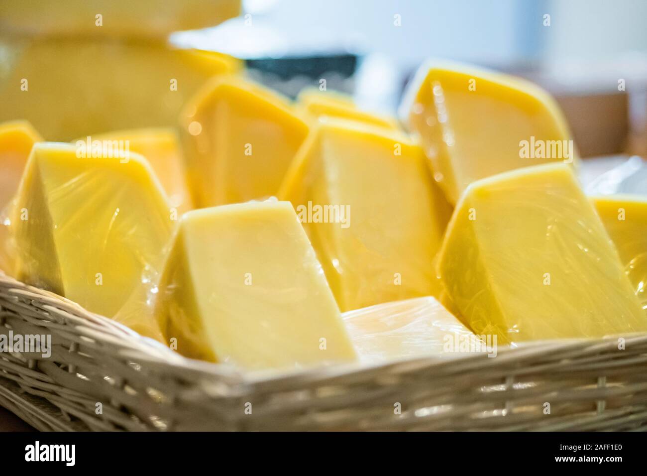 Delicious handmade yellow cheeses for sale on counter Stock Photo - Alamy