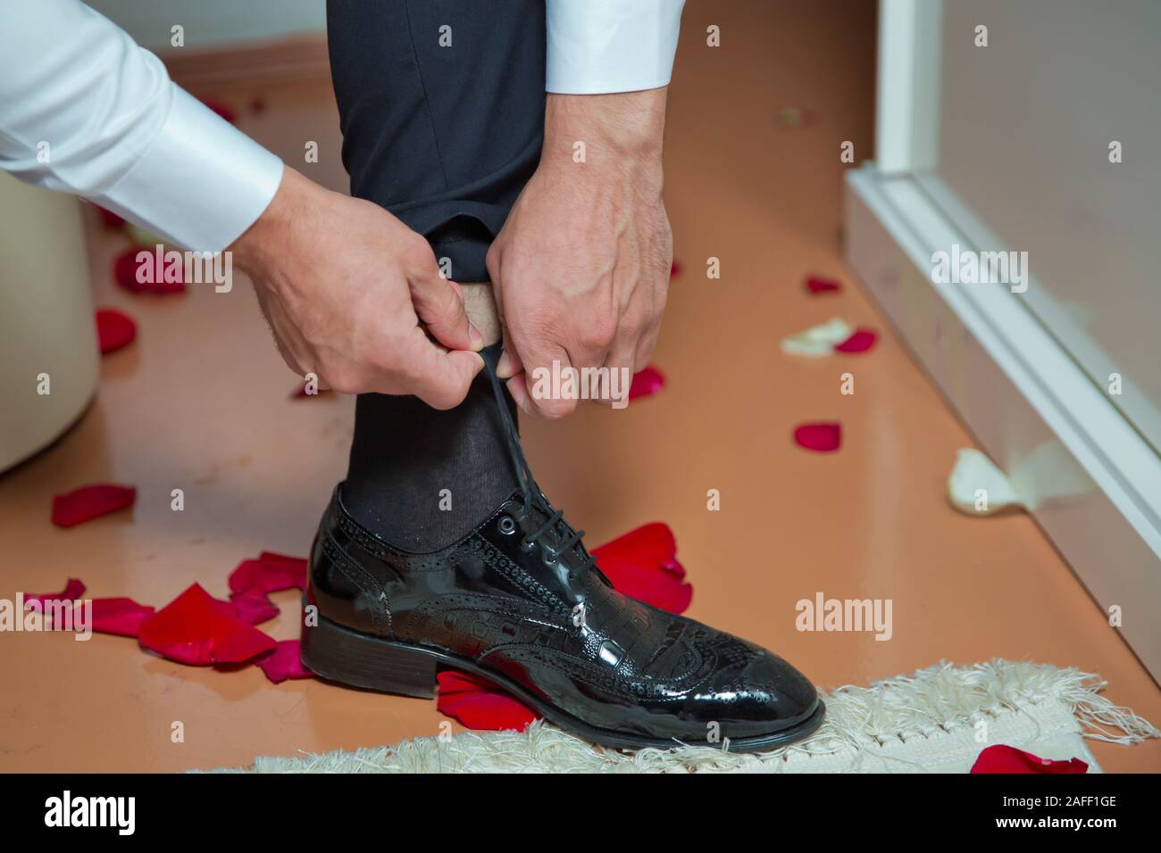 Businessman putting on shoes hi-res stock photography and images - Alamy
