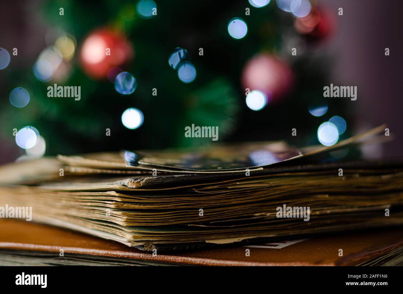 Vintage photo album on Christmas tree background. Family traditions and ...