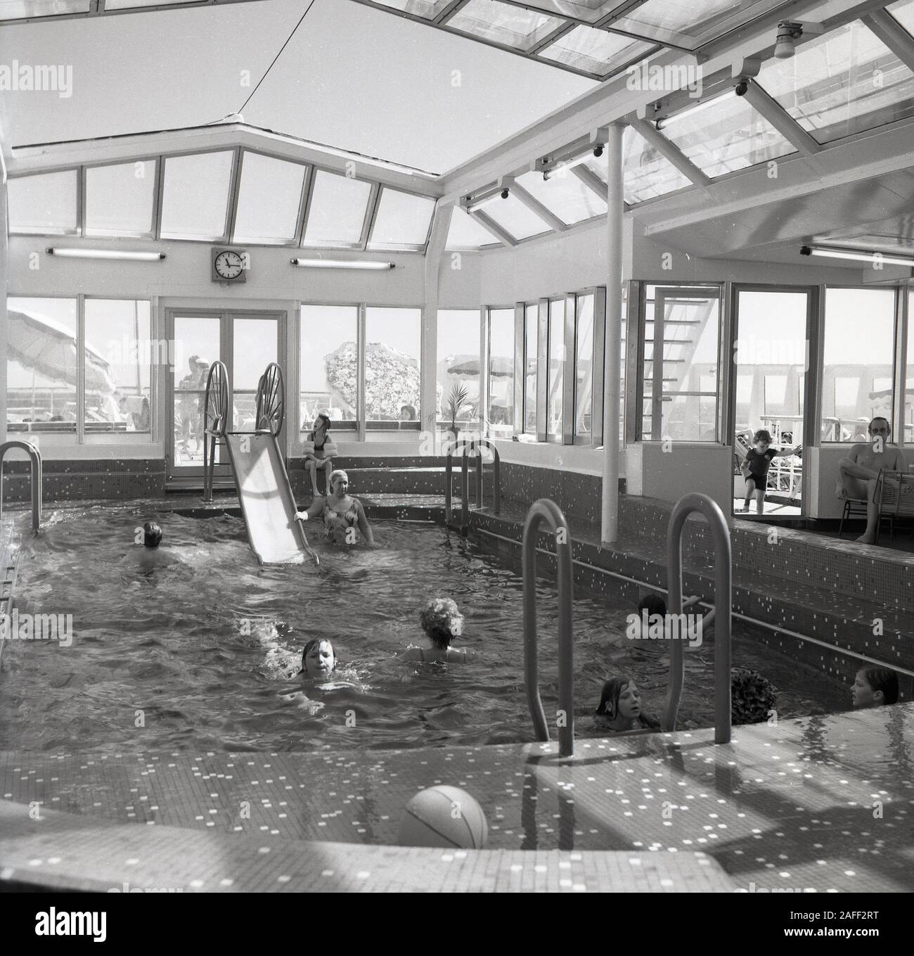 1960s, historical, an enclosed swimming pool on a luxury cruise ship ...
