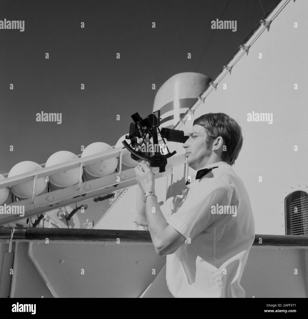 1960s, historical, a uniformed navigator outside on the deck of a ...