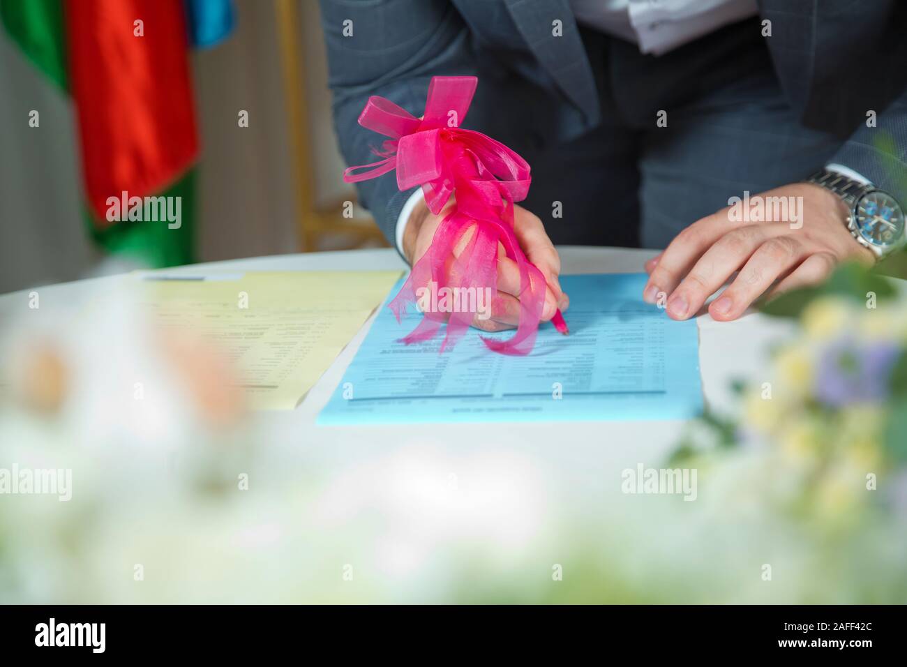 The newlyweds put their signature on the marriage . the bride in a ...