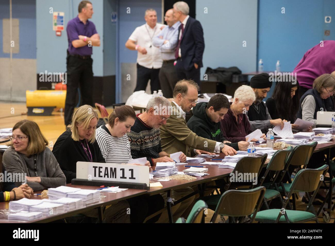 Maidenhead, UK. 12 December, 2019. Counting staff verify and count the ...