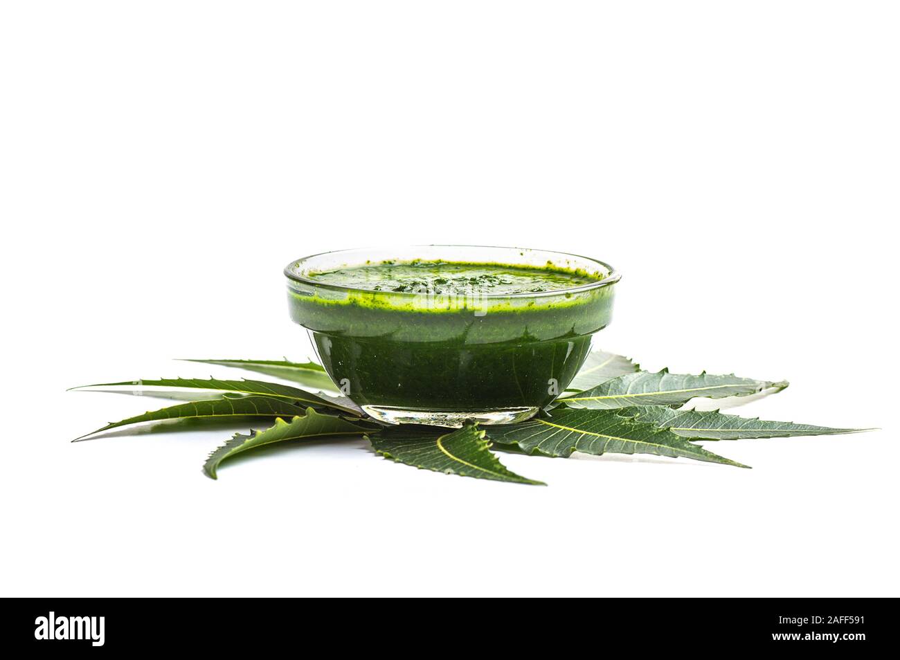 Medicinal Neem leaves with paste in bowl on white background Stock ...