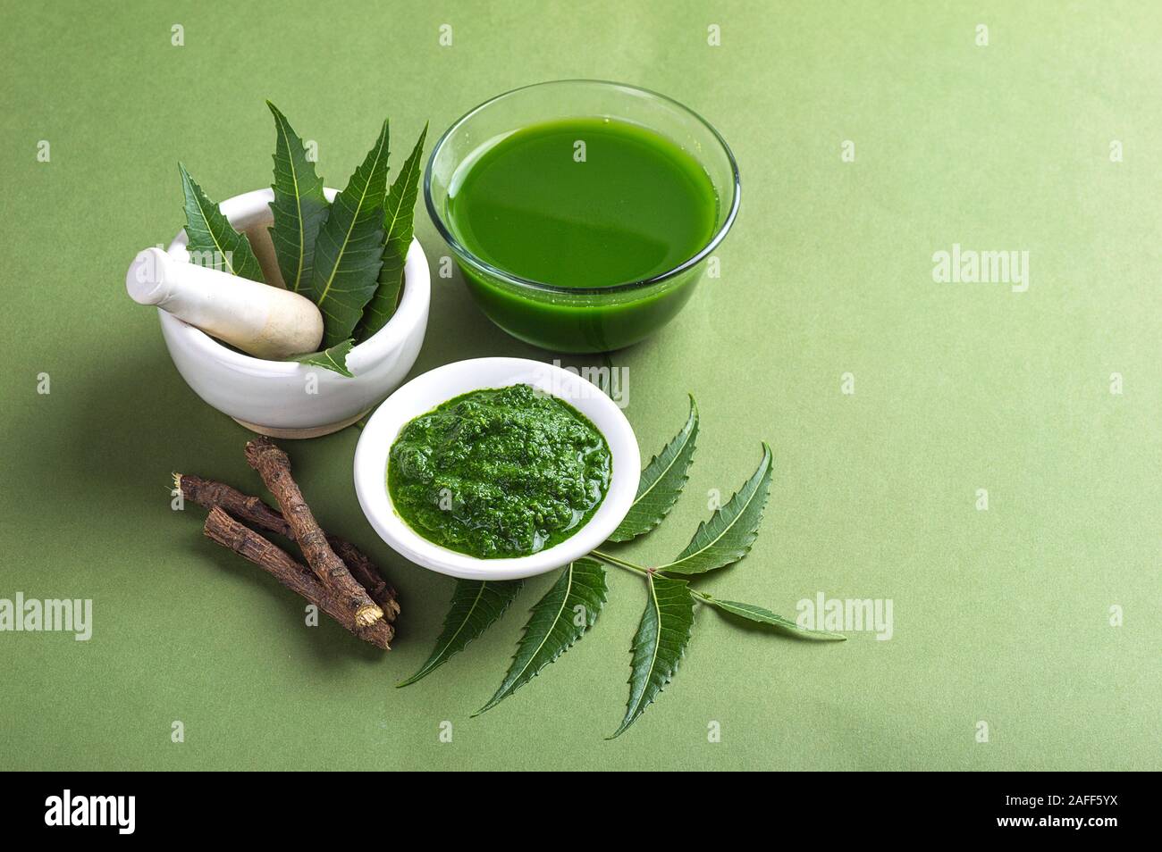 Medicinal Neem leaves in mortar and pestle with neem paste, juice and ...