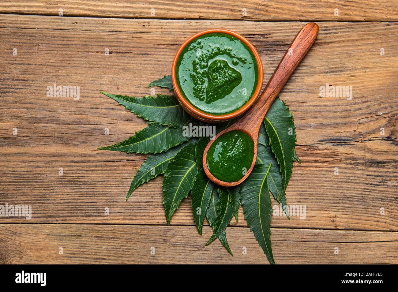 Medicinal Neem leaves with paste on wooden background Stock Photo - Alamy