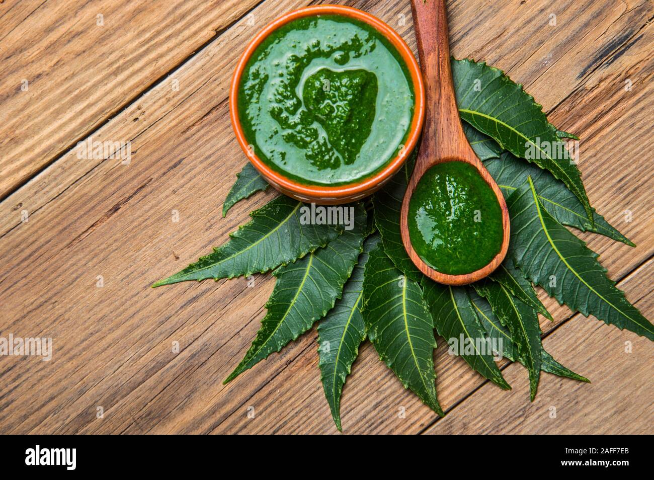 Medicinal Neem leaves with paste on wooden background Stock Photo - Alamy