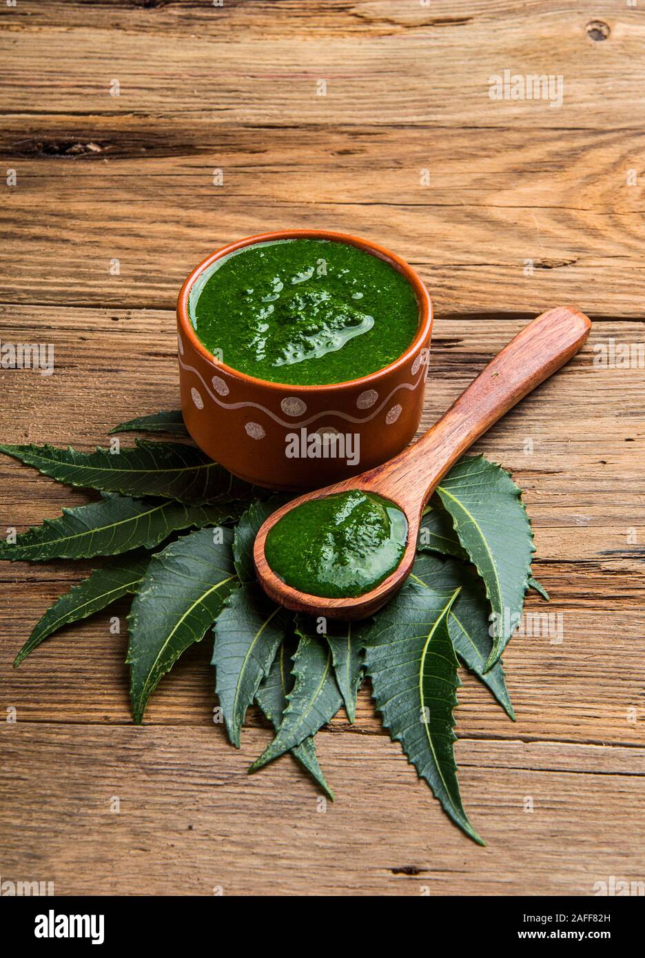 Medicinal Neem leaves with paste on wooden background Stock Photo - Alamy