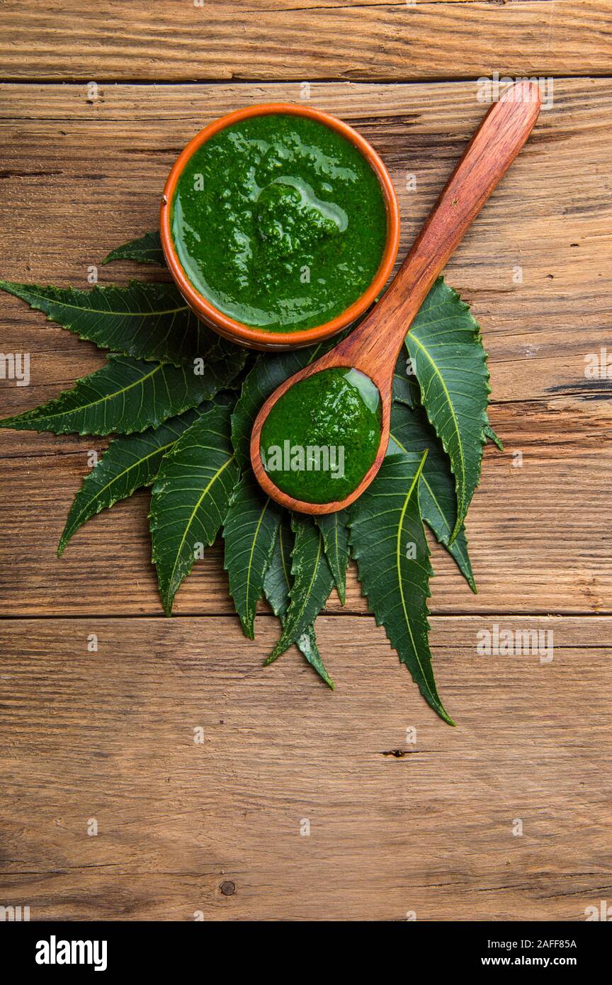 Medicinal Neem leaves with paste on wooden background Stock Photo - Alamy