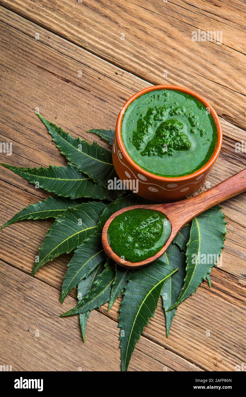 Medicinal Neem leaves with paste on wooden background Stock Photo - Alamy
