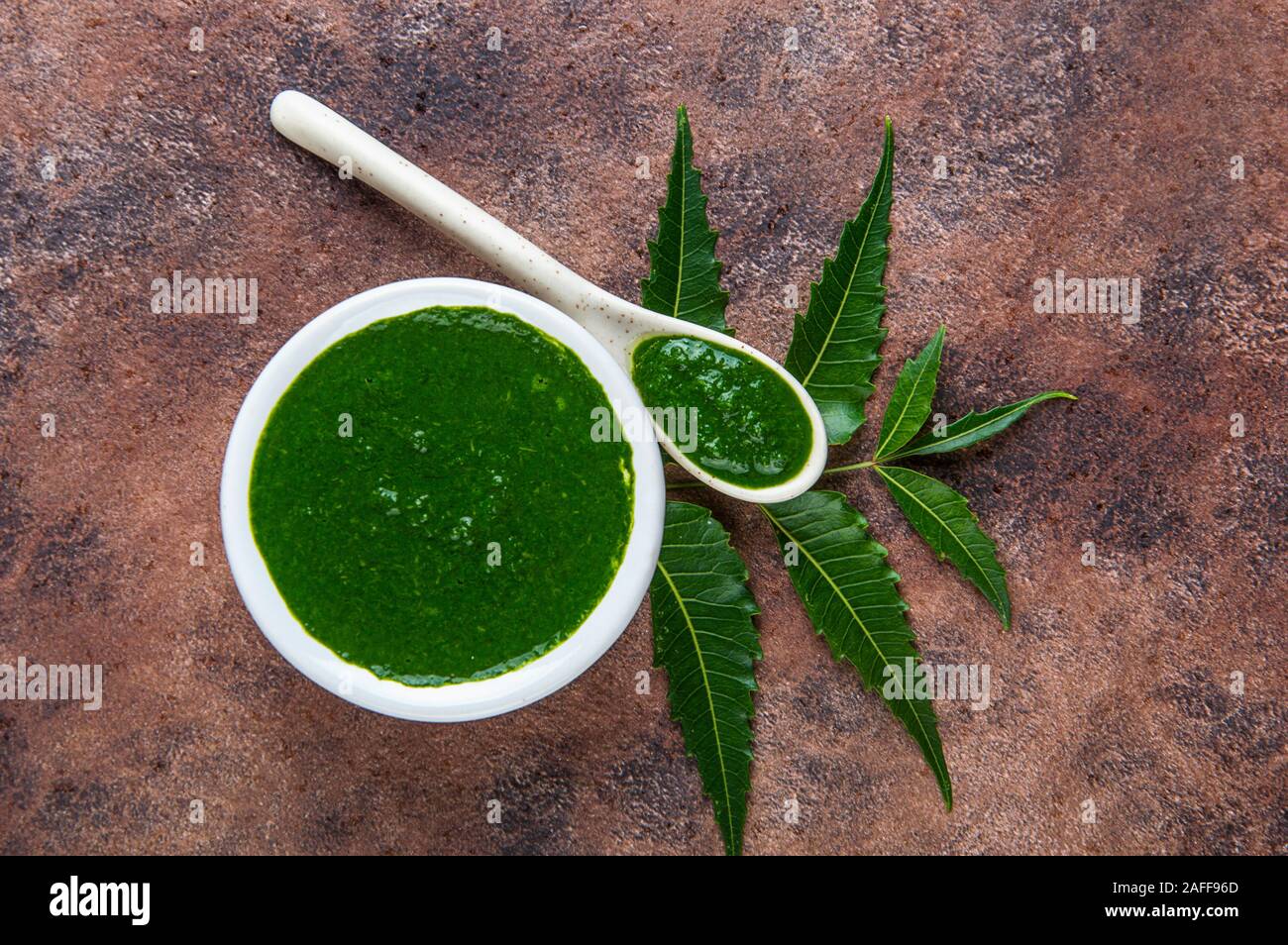 Medicinal Neem leaves with paste on stone background Stock Photo - Alamy