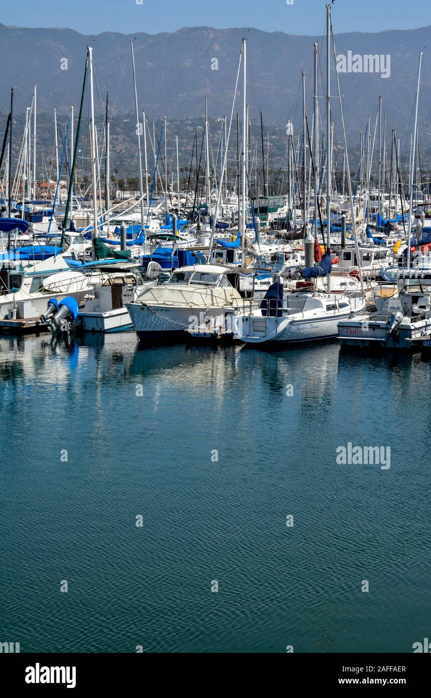 A view of mostly sailboat masts jutting into the sky against the Santa ...