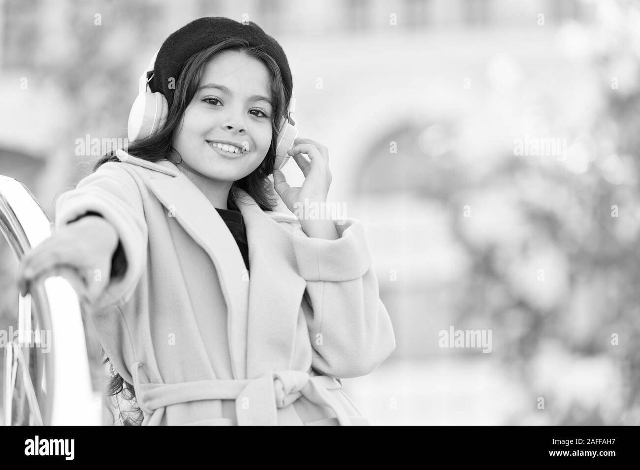 Favorite band. Influence of music. Child girl autumn outfit enjoying ...