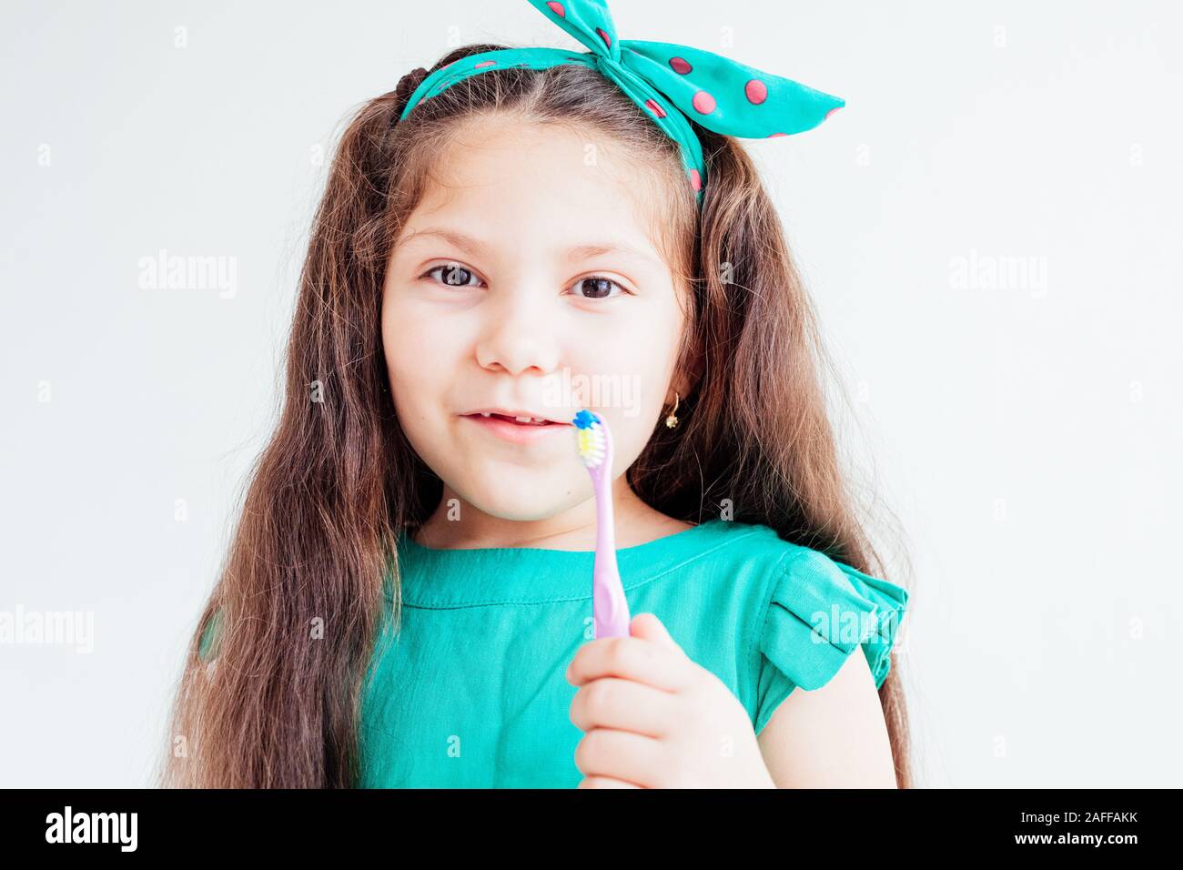 little girl with no teeth with a toothbrush in dentistry Stock Photo ...