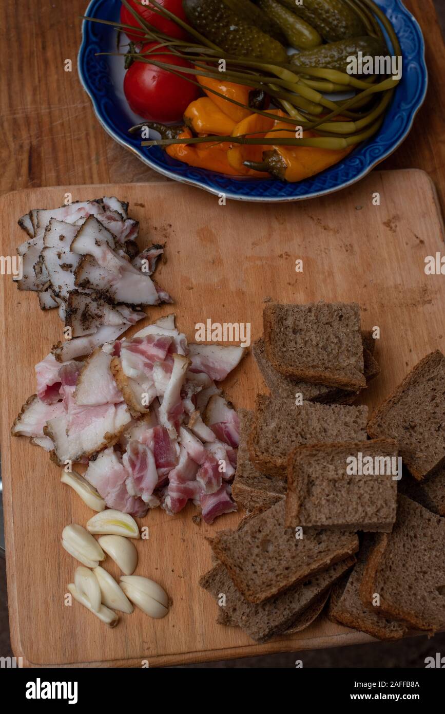 Bacon, bread and cucumber over wooden background. Russian and ukrainian ...