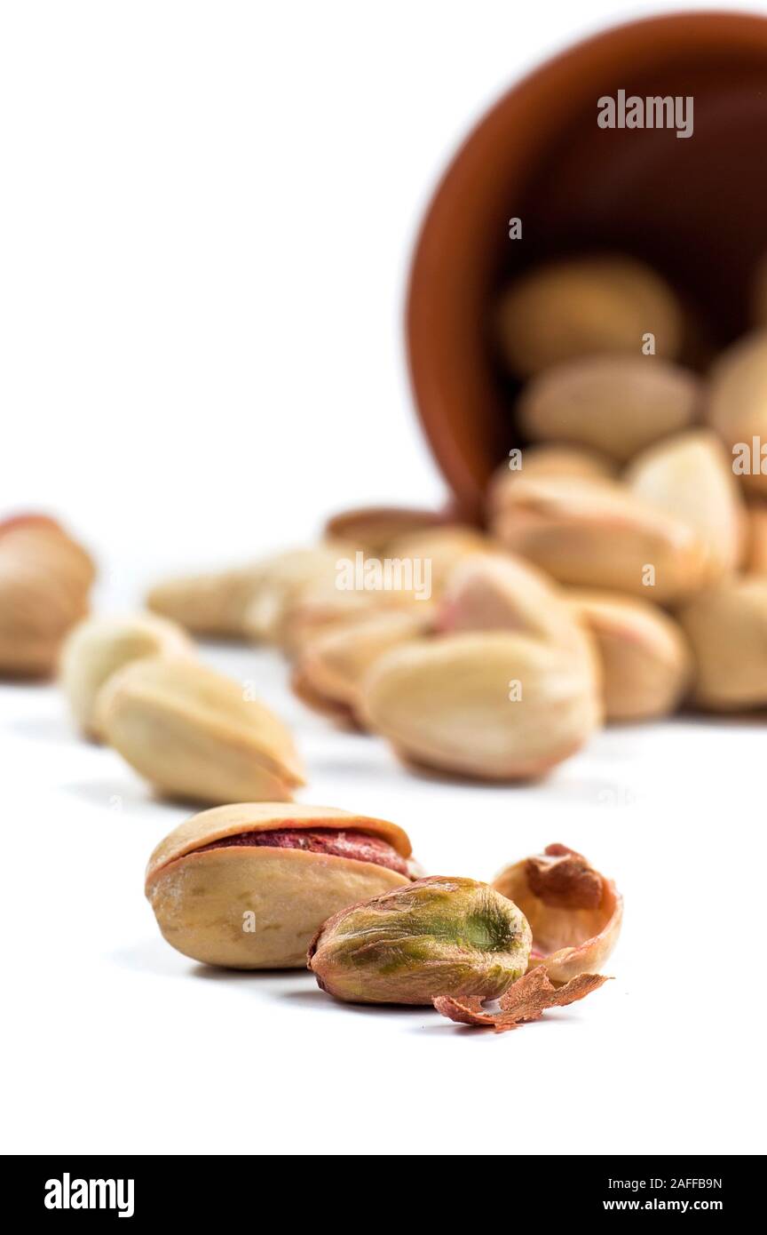 Pistachio and Cashew Nuts in clay pots on white background Stock Photo ...
