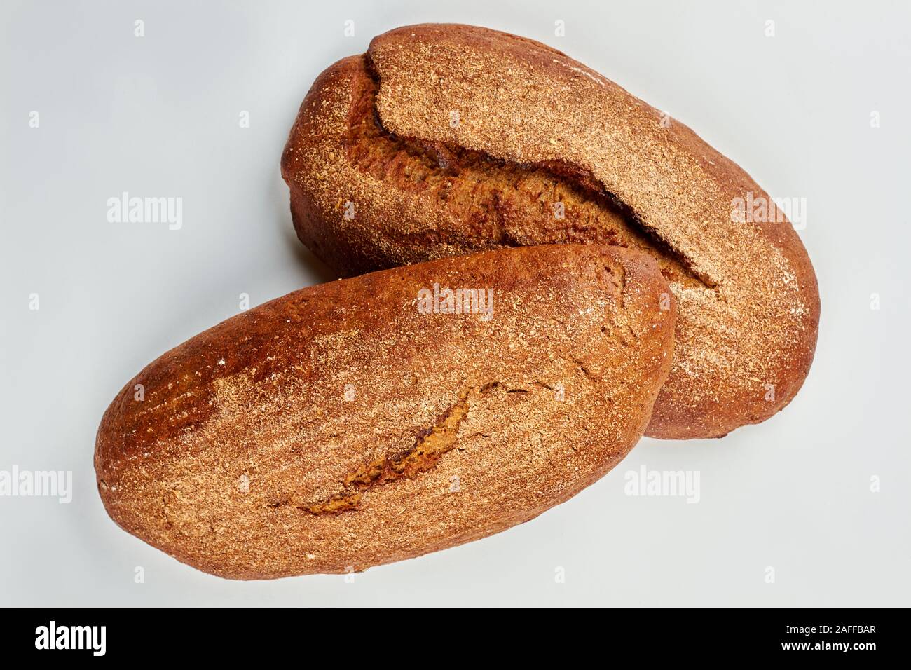 Two loaves of bread on white background Stock Photo - Alamy
