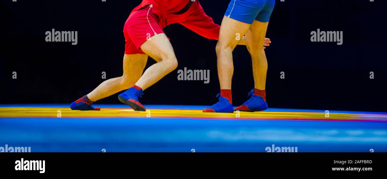 Sambo fighter attacking his opponent with leg technique Stock Photo - Alamy