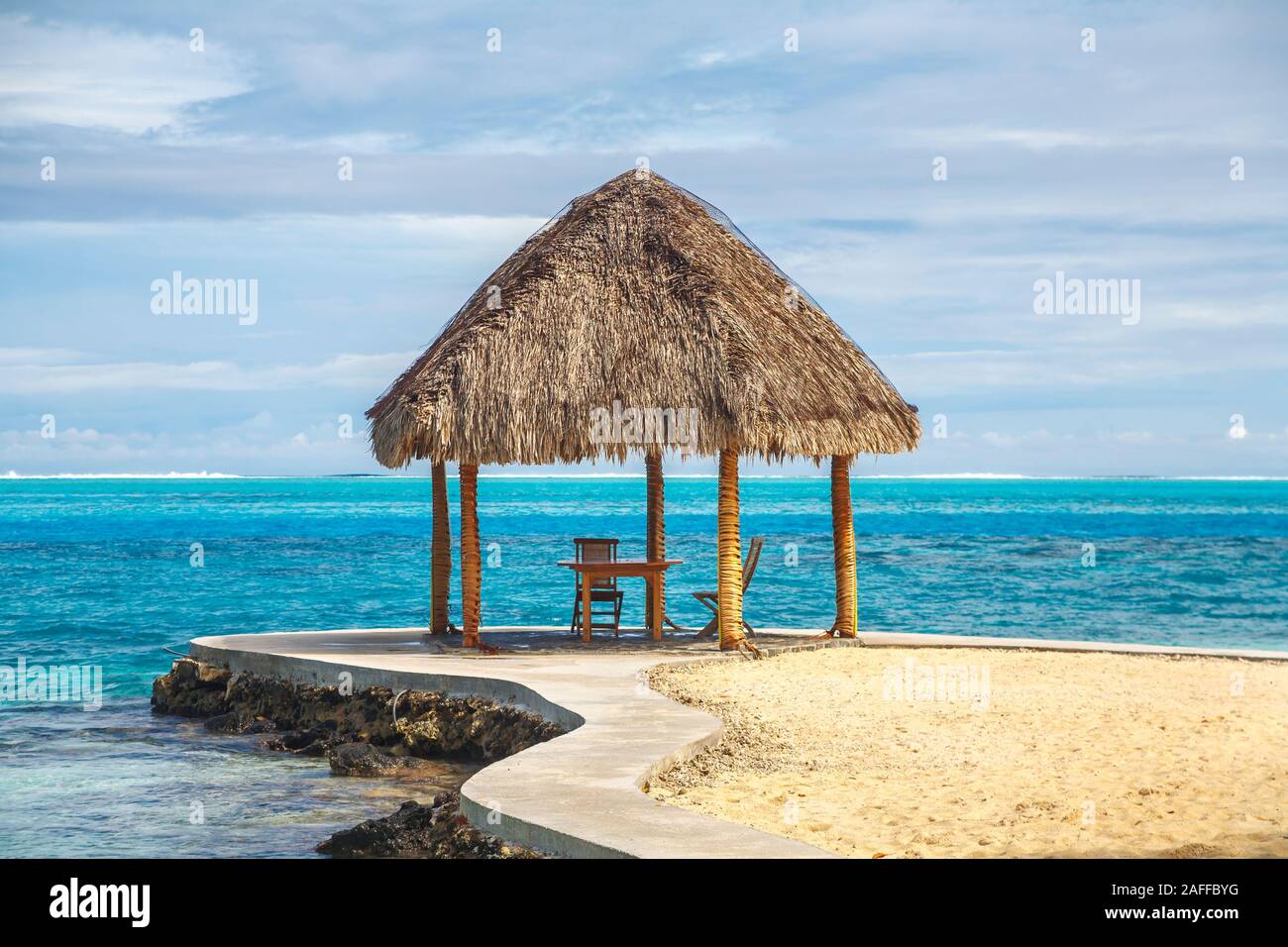 View of typical thatched seashore gazebo or breeze house or hut, by a ...