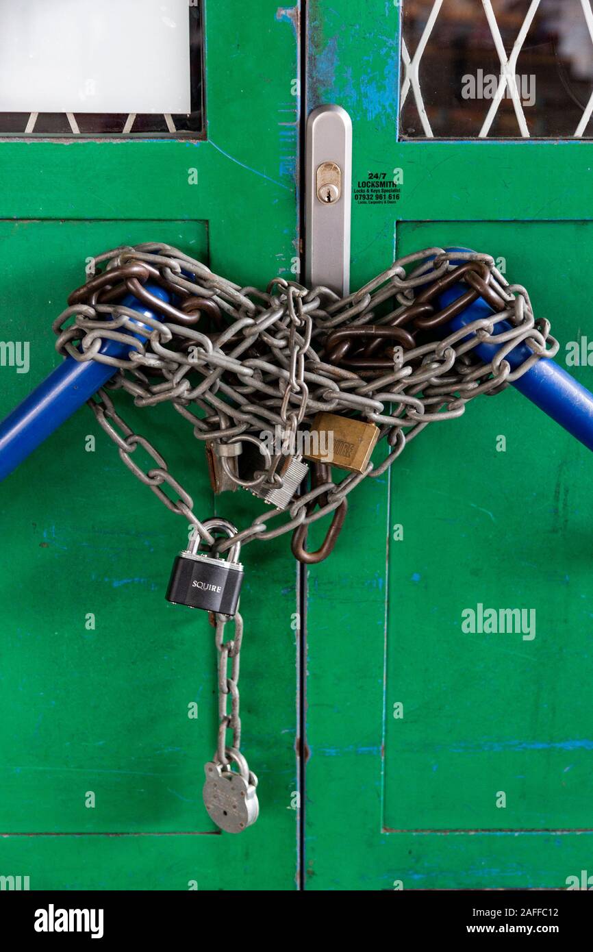 Door secured by heavy chain and many locks, London, England, United ...