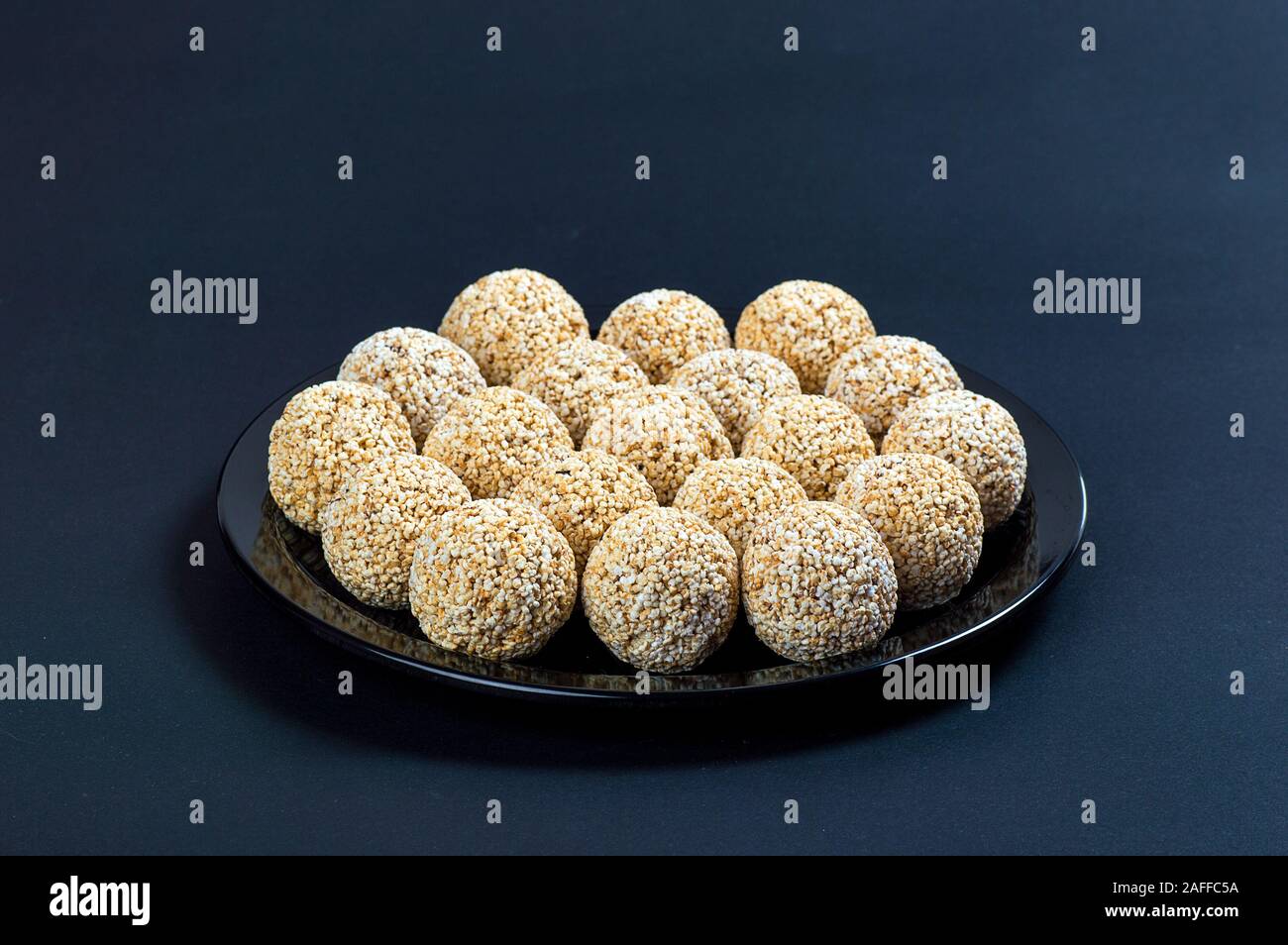 Amaranth ladoo or Rajgira laddu or Cholai ke laddo in black plate on ...