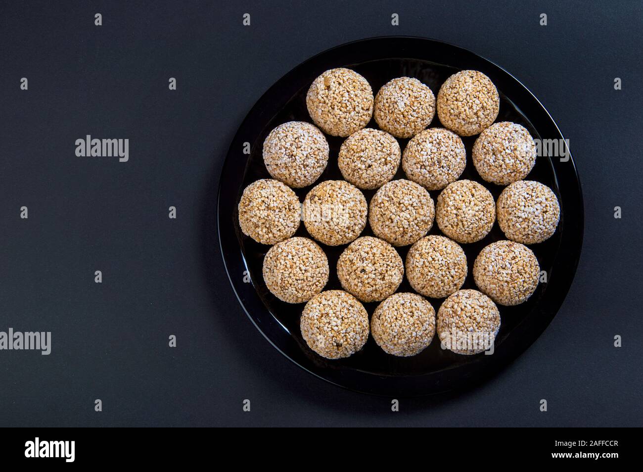 Amaranth ladoo or Rajgira laddu or Cholai ke laddo in black plate on ...
