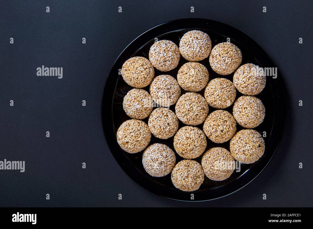 Amaranth ladoo or Rajgira laddu or Cholai ke laddo in black plate on ...