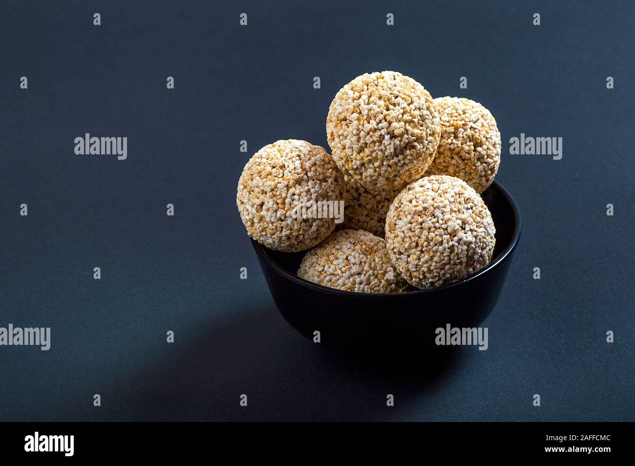 Amaranth or Rajgira laddu, Cholai ke laddo in black Bowl on black ...