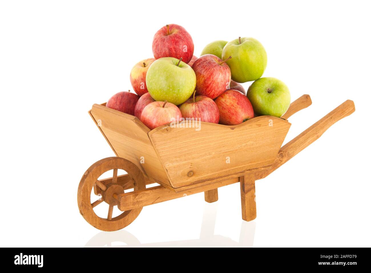 Wheel barrow with red and green apples isolated over white background ...